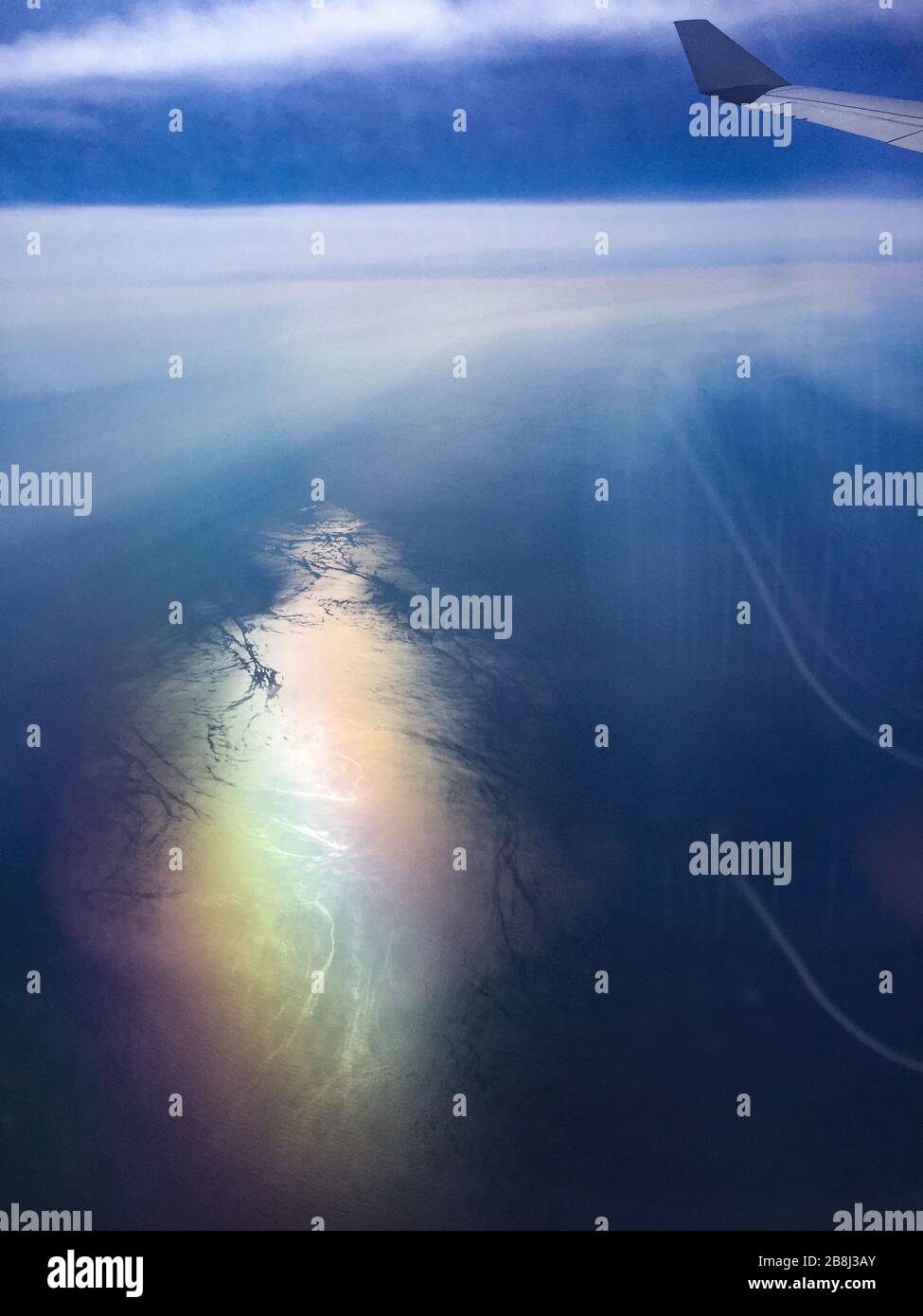 Sun reflects on the water forming rainbow colors shot from high above ...