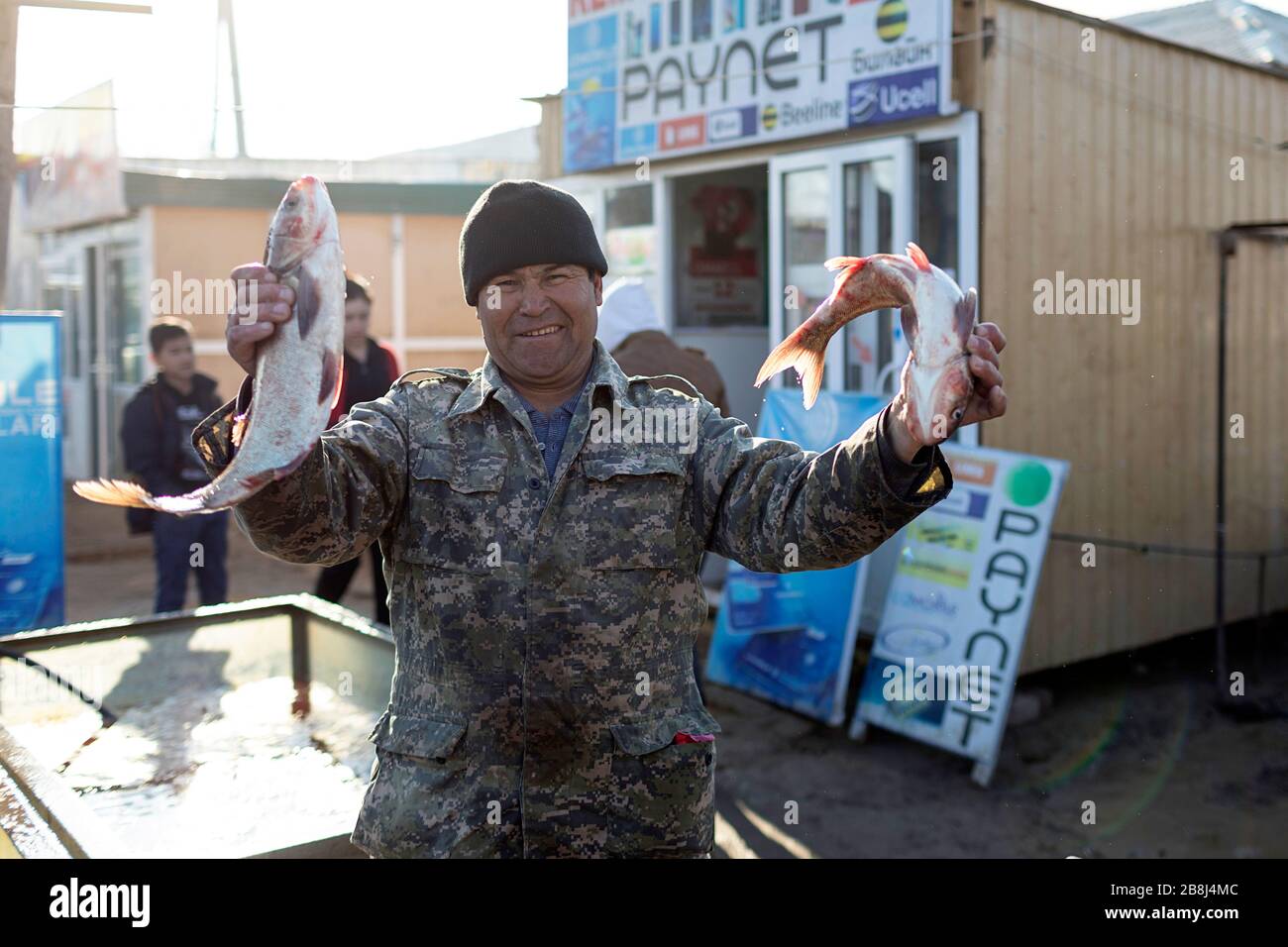 Seller holding fish in his hands at the fish market at the Street ...
