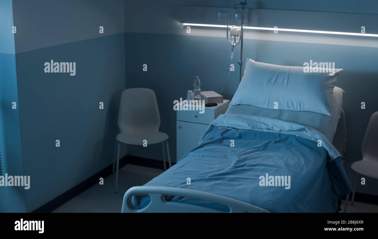 Clean hospital room interior at night with bed and medical equipment ...