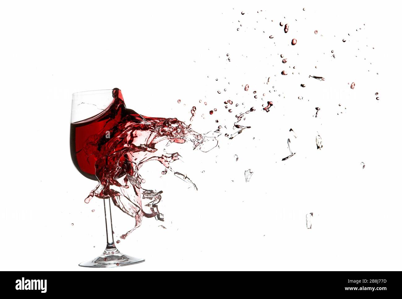 Explosion of a glass with red wine on white background Stock Photo - Alamy