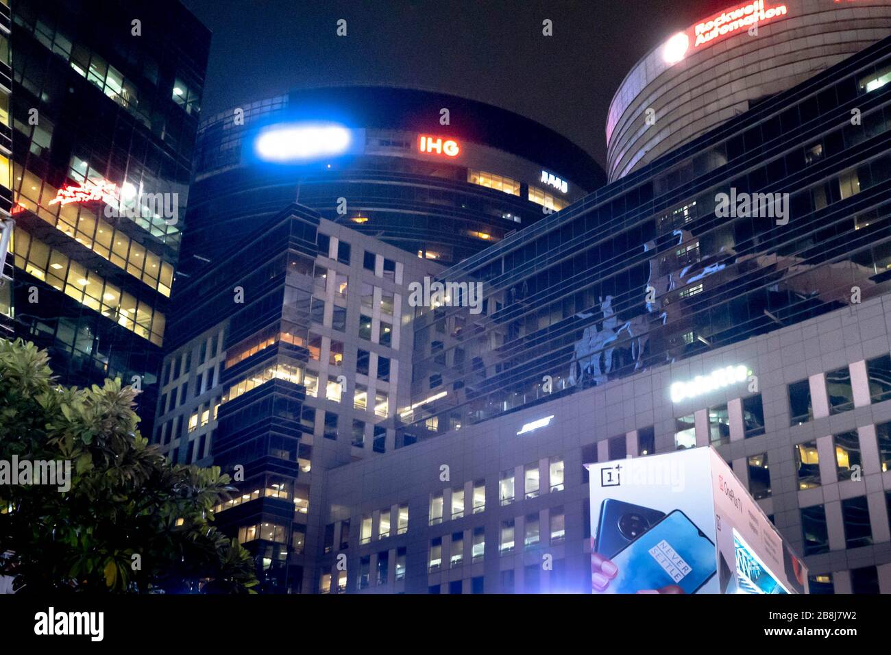 Night shot of huge skyscraper glass buildings with lit windows, lights ...