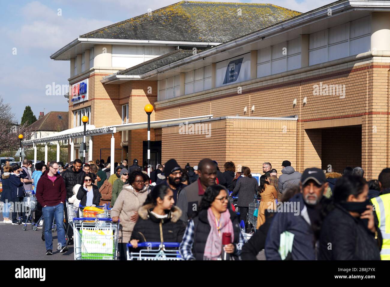 People queue at a Tesco Extra in Osterley, London, the day after Tesco ...