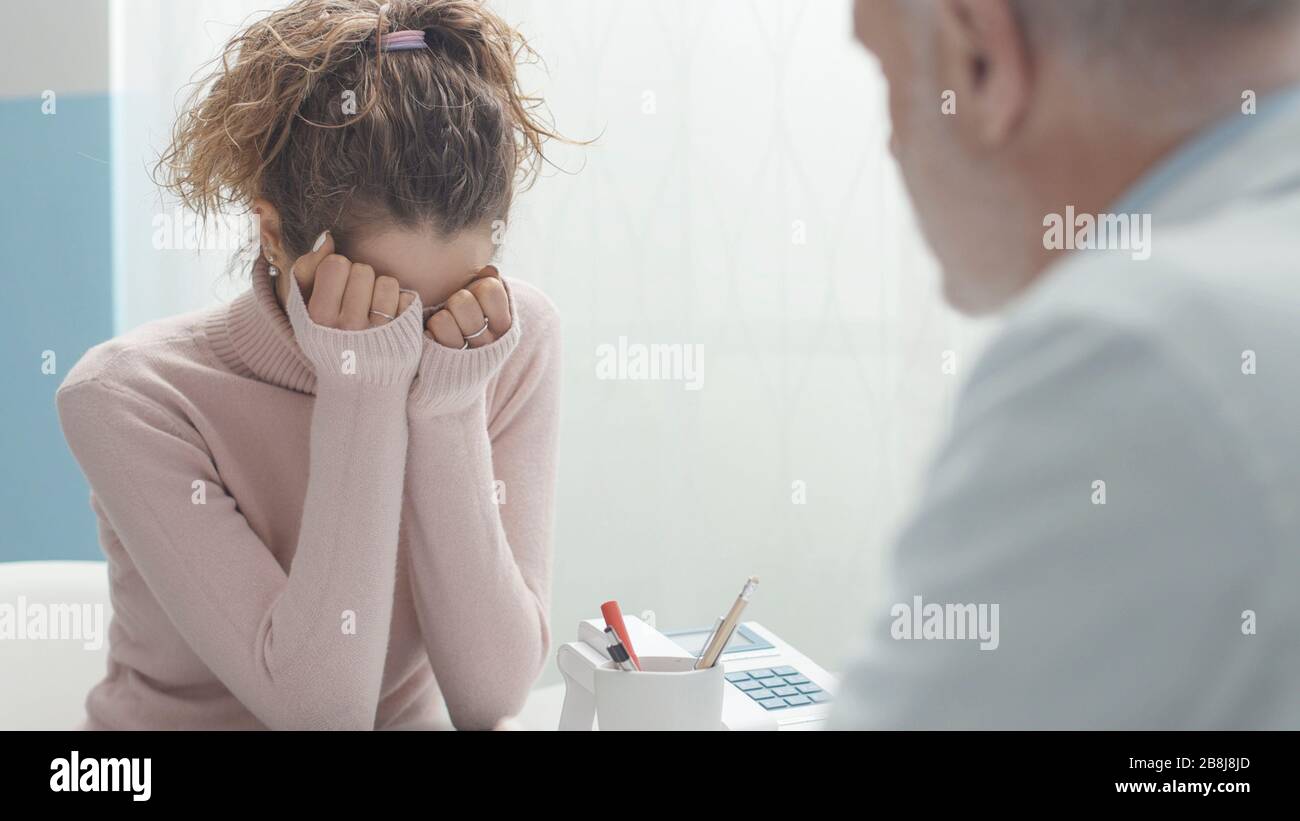 Sad woman meeting her doctor and receiving a bad diagnosis, she is ...