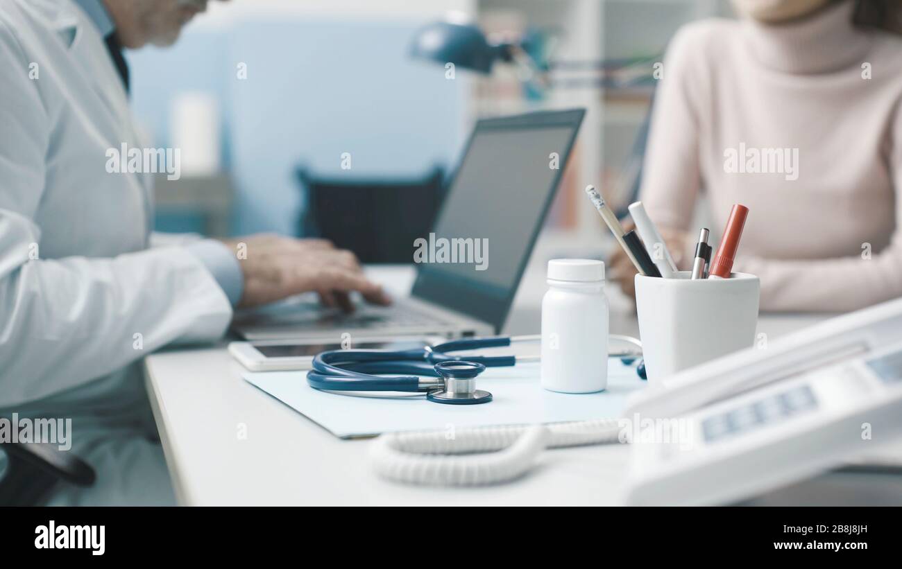 Consultation doctor typing patient hi-res stock photography and images ...