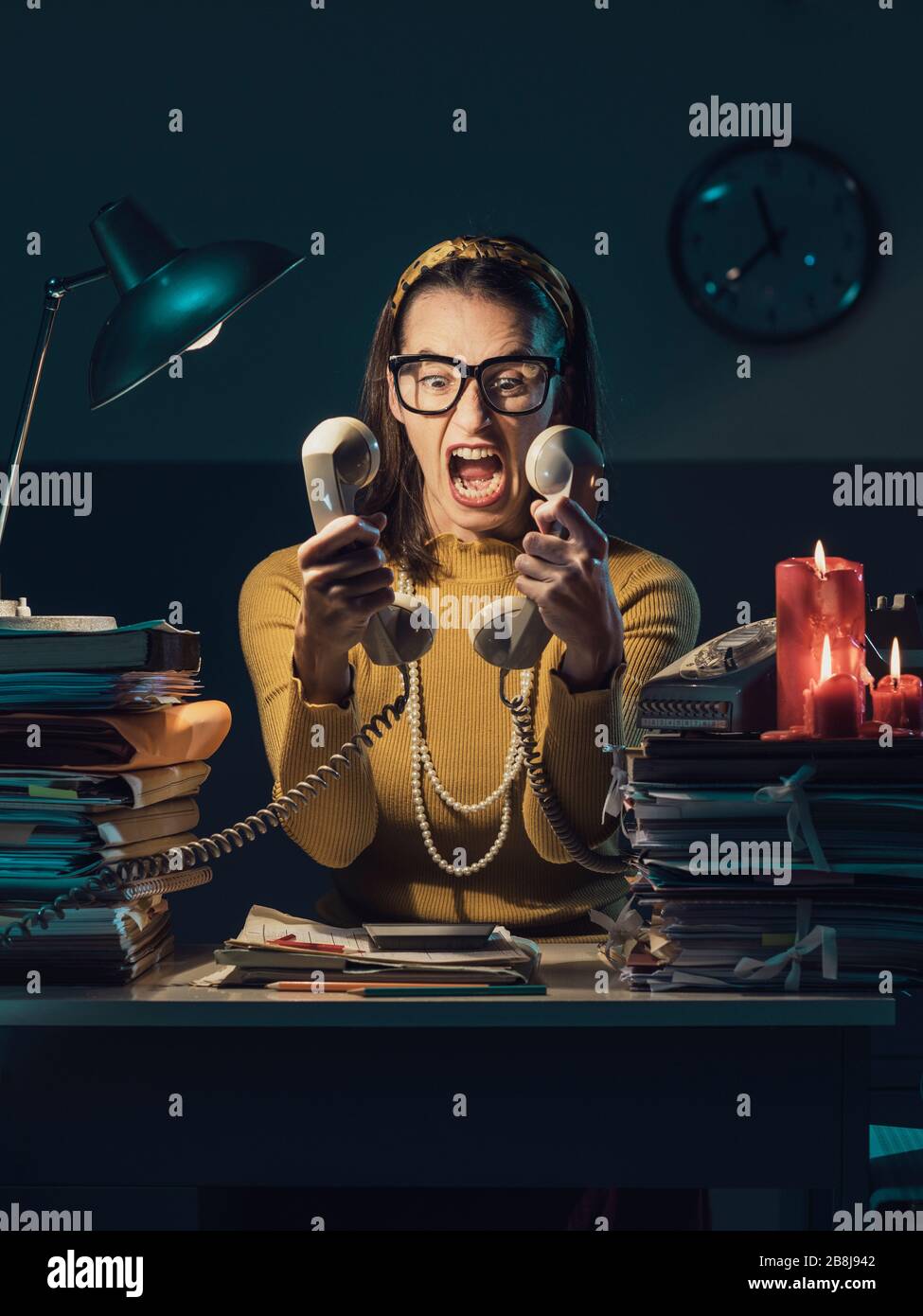 Angry stressed secretary working in the office at night and shouting at ...