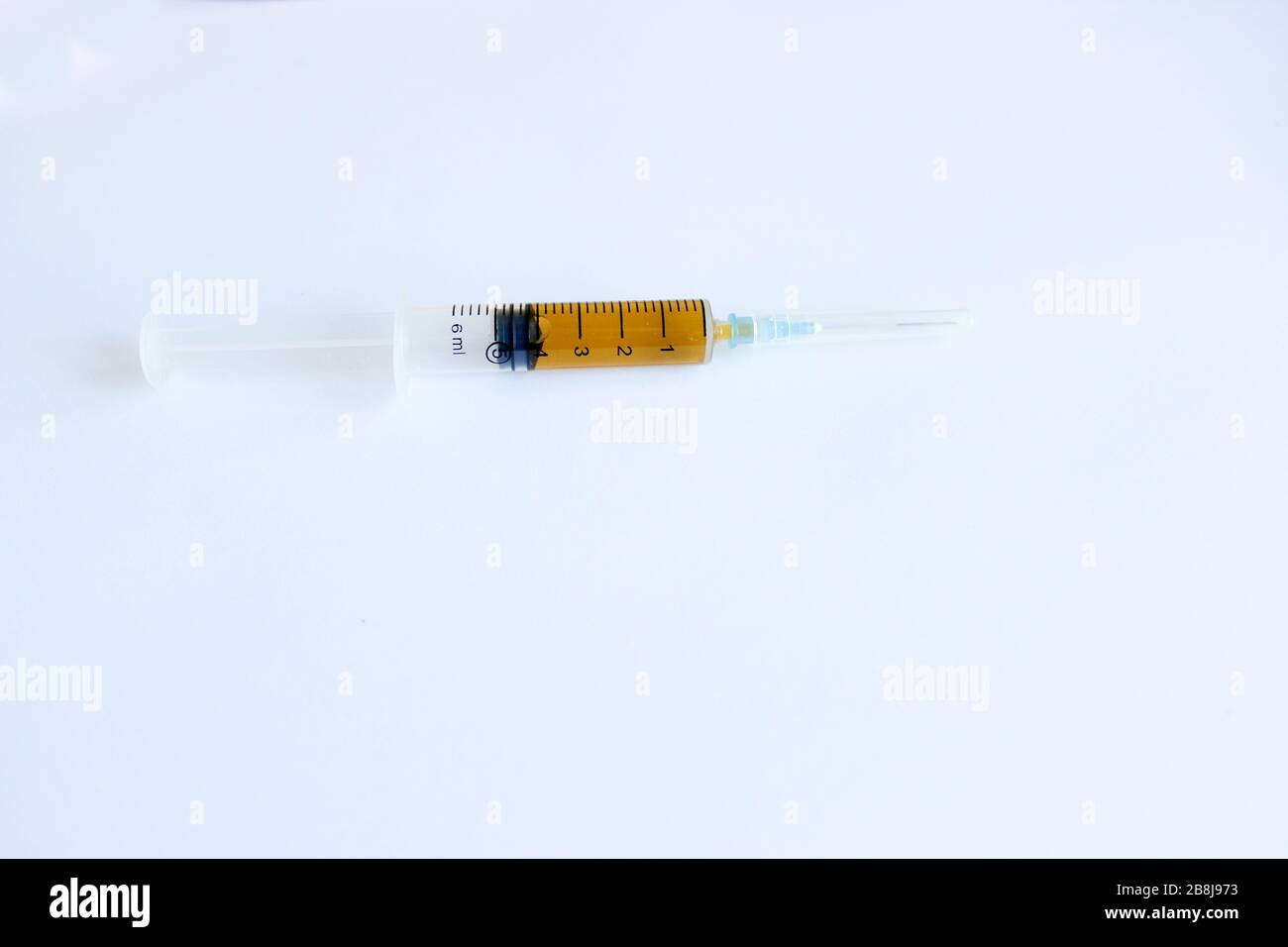 Medical syringe on a white background filled with liquid and medicine ...