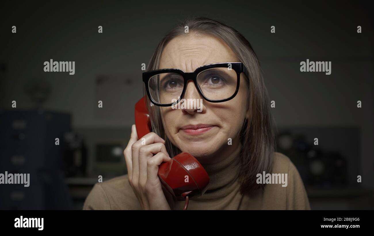 Disappointed woman with glasses having a boring phone call Stock Photo ...
