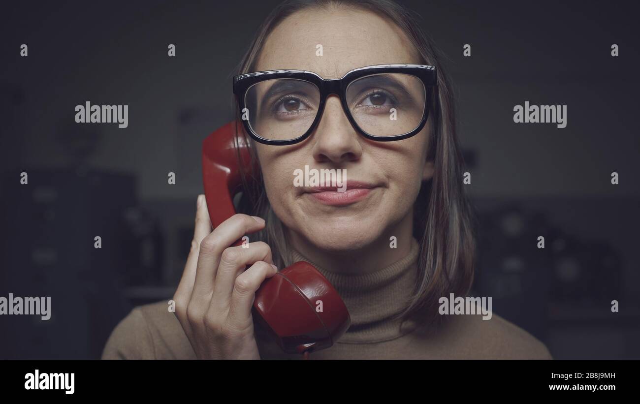 Disappointed woman with glasses having a boring phone call Stock Photo ...