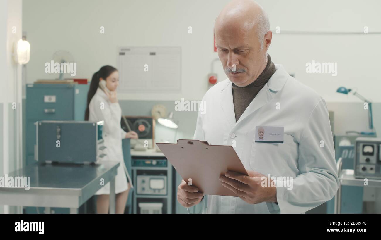 Senior scientist working in a vintage style laboratory with retro ...