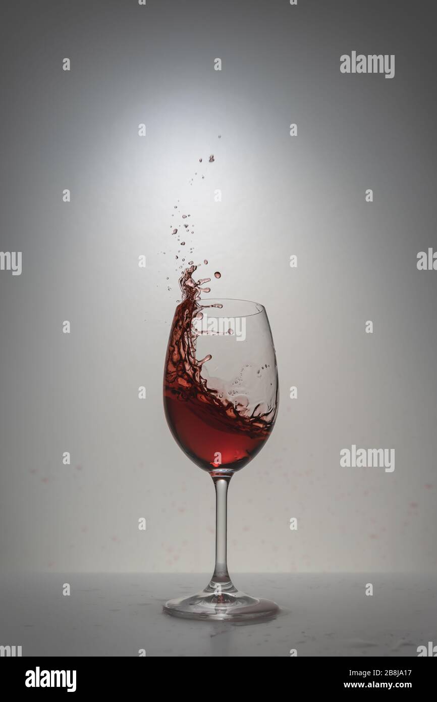 red wine splash in a red wine glass Stock Photo - Alamy