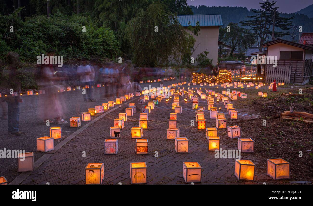 Hundreds of paper lanterns with candles, with long-exposure ghosts of ...