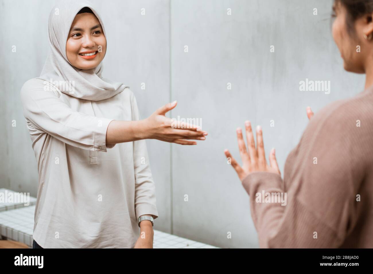 social distancing. woman refuse to touch while meeting with friend ...