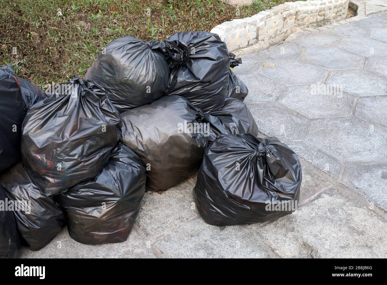 waste lots pile of garbage black bags plastic stack on the floor ground ...