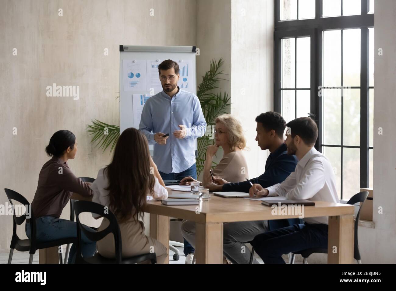 Male speaker present project on whiteboard at meeting Stock Photo - Alamy