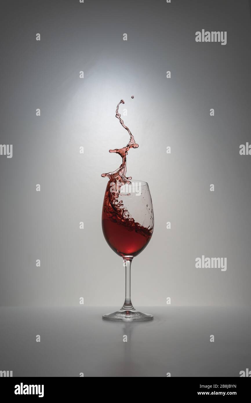 red wine splash in a red wine glass Stock Photo - Alamy