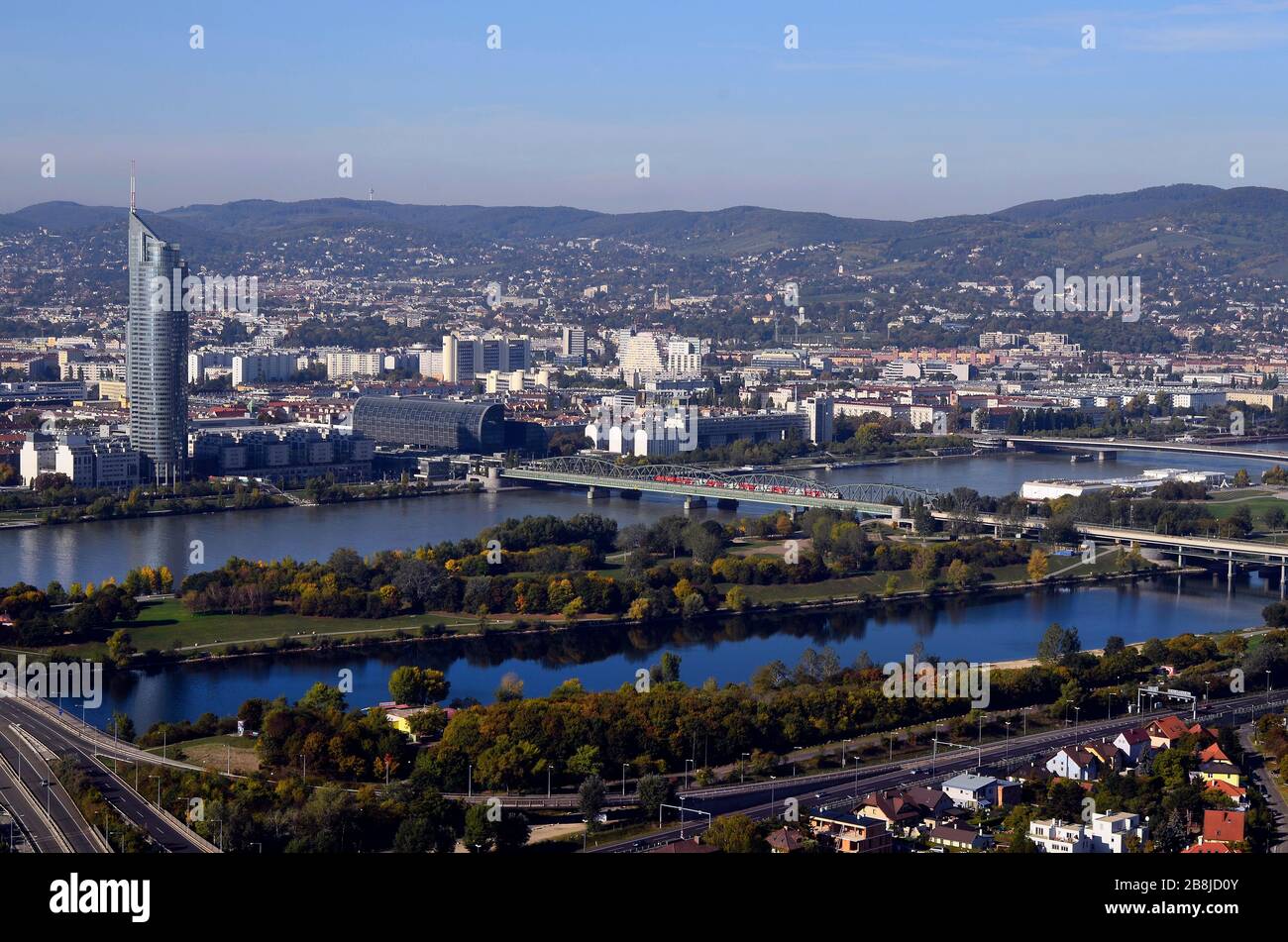 Austria, Vienna, Millennium Tower and bridge over Danube river with ...