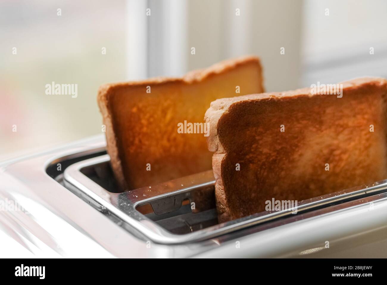 Toaster with ready bread slices in the kitchen. traditional breakfast ...