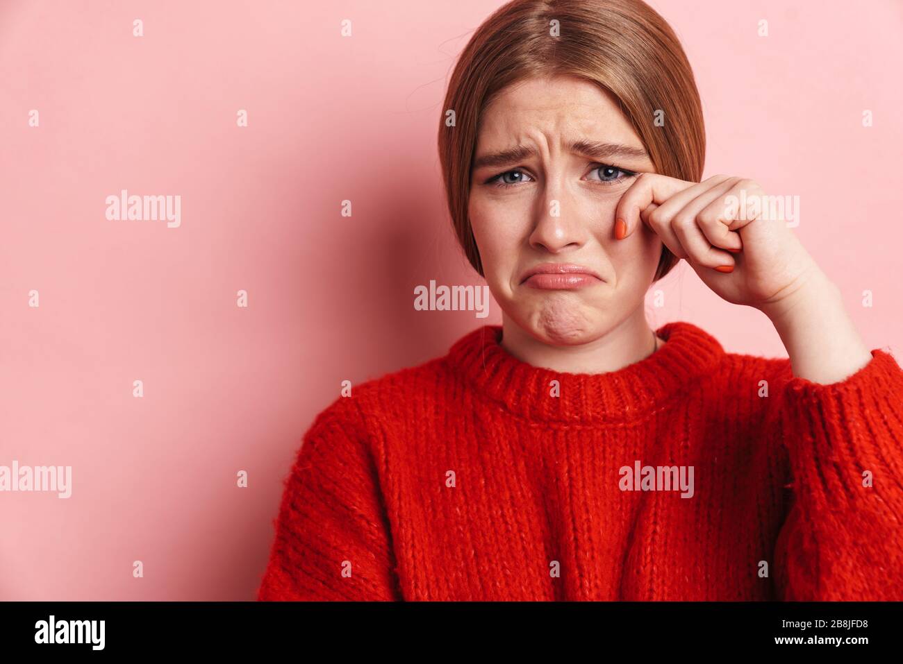 Image of sad negative young woman posing isolated over pink wall ...