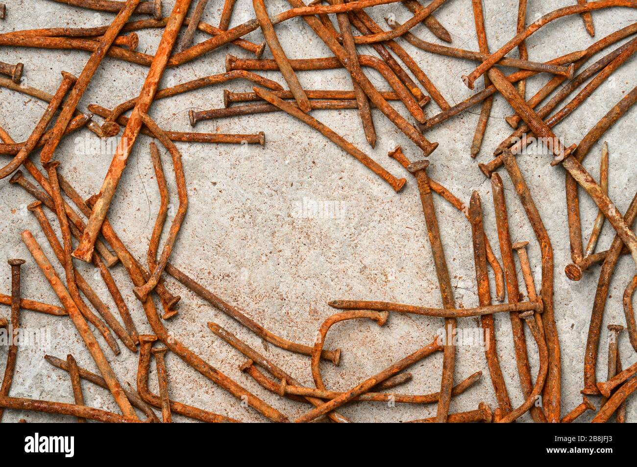 Rusty used nails on a cement metal background Stock Photo - Alamy