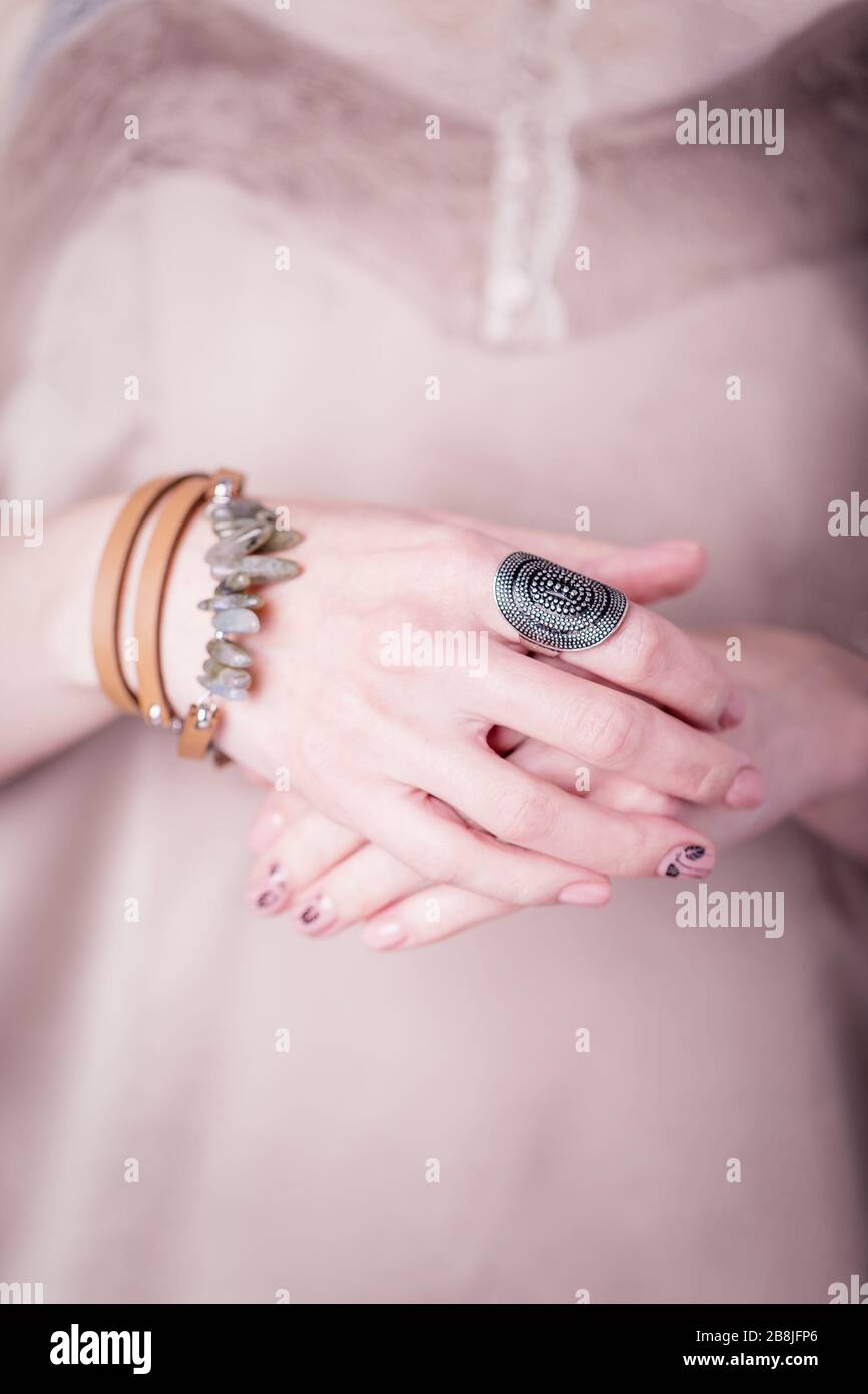 Beautiful female hands on light beige silk background. Manicure with ...