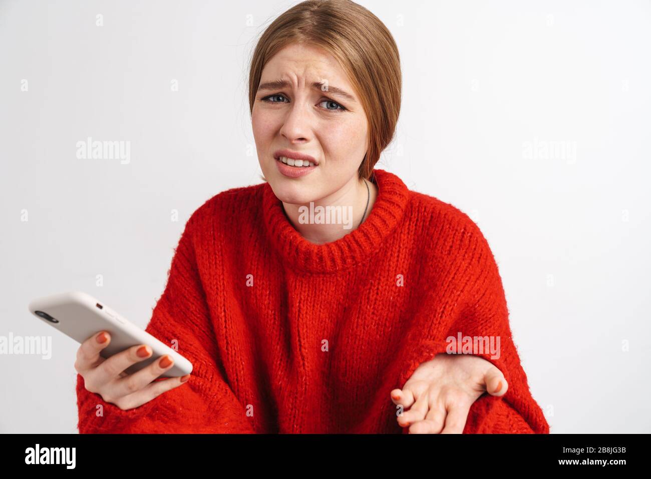 Picture of displeased confused young woman posing isolated over white ...
