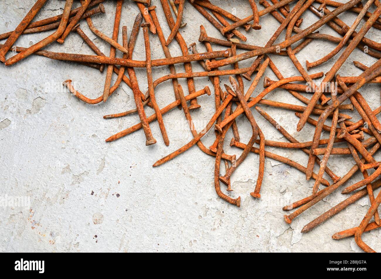 Rusty used nails on a cement metal background Stock Photo - Alamy