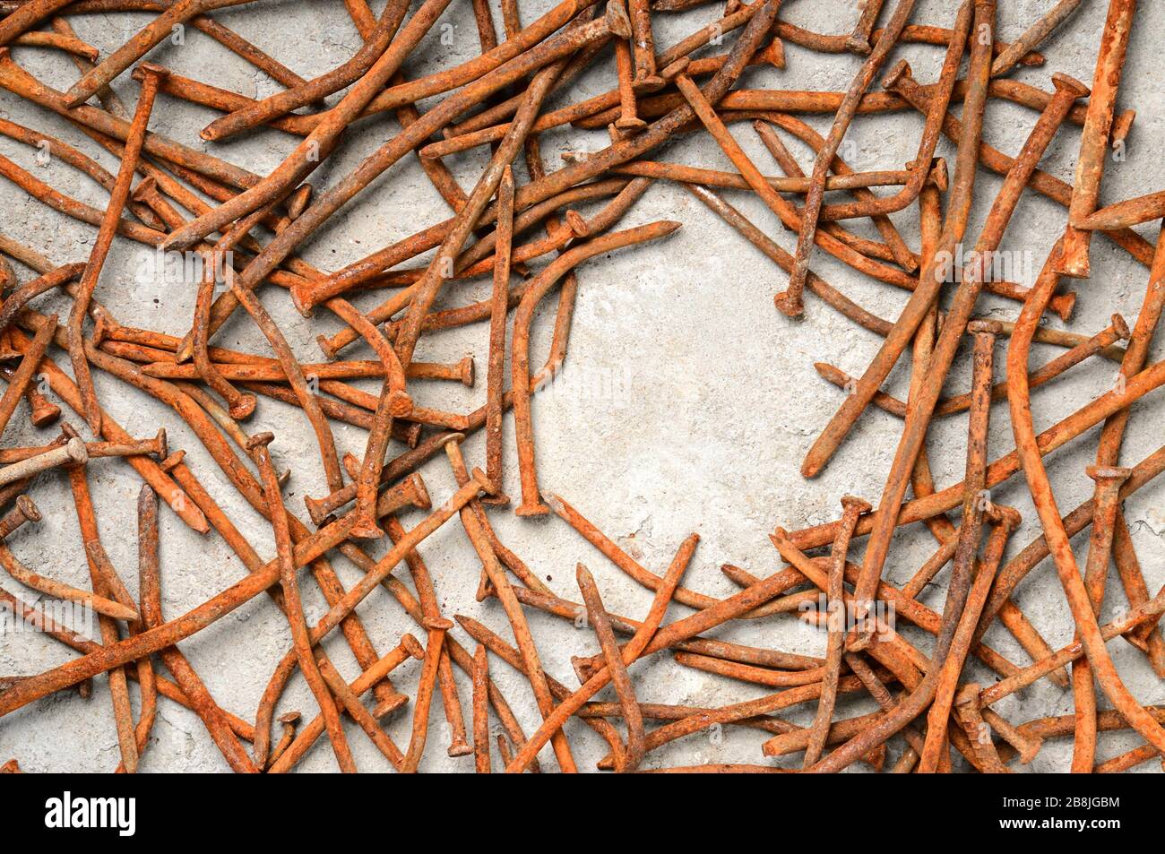 Rusty used nails on a cement metal background Stock Photo - Alamy