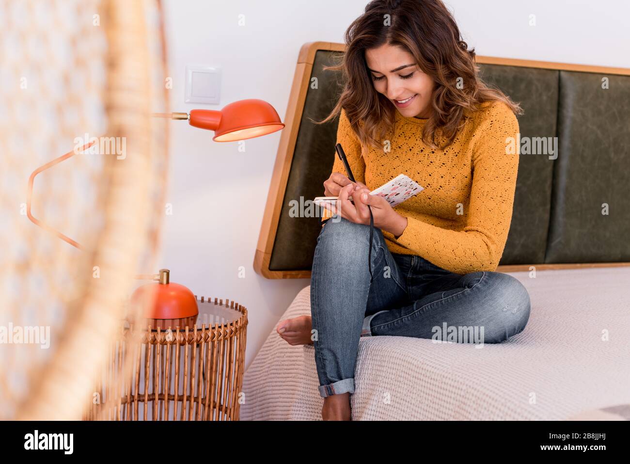 Young Woman writting some notes into her diary Stock Photo - Alamy