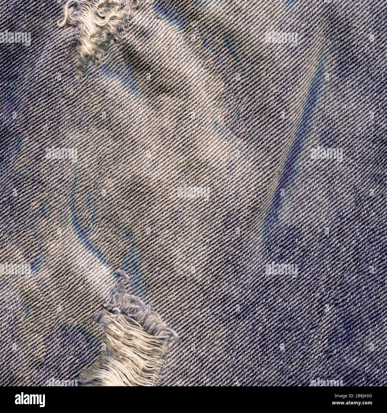 Blue torn grunge denim jeans texture. Jeans bit torn Stock Photo - Alamy