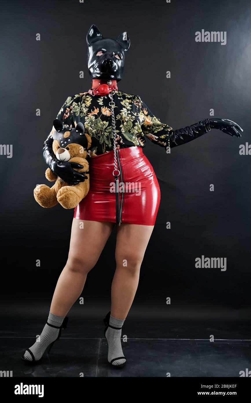 plus size woman with rubber mask for protection posing with her teddy ...