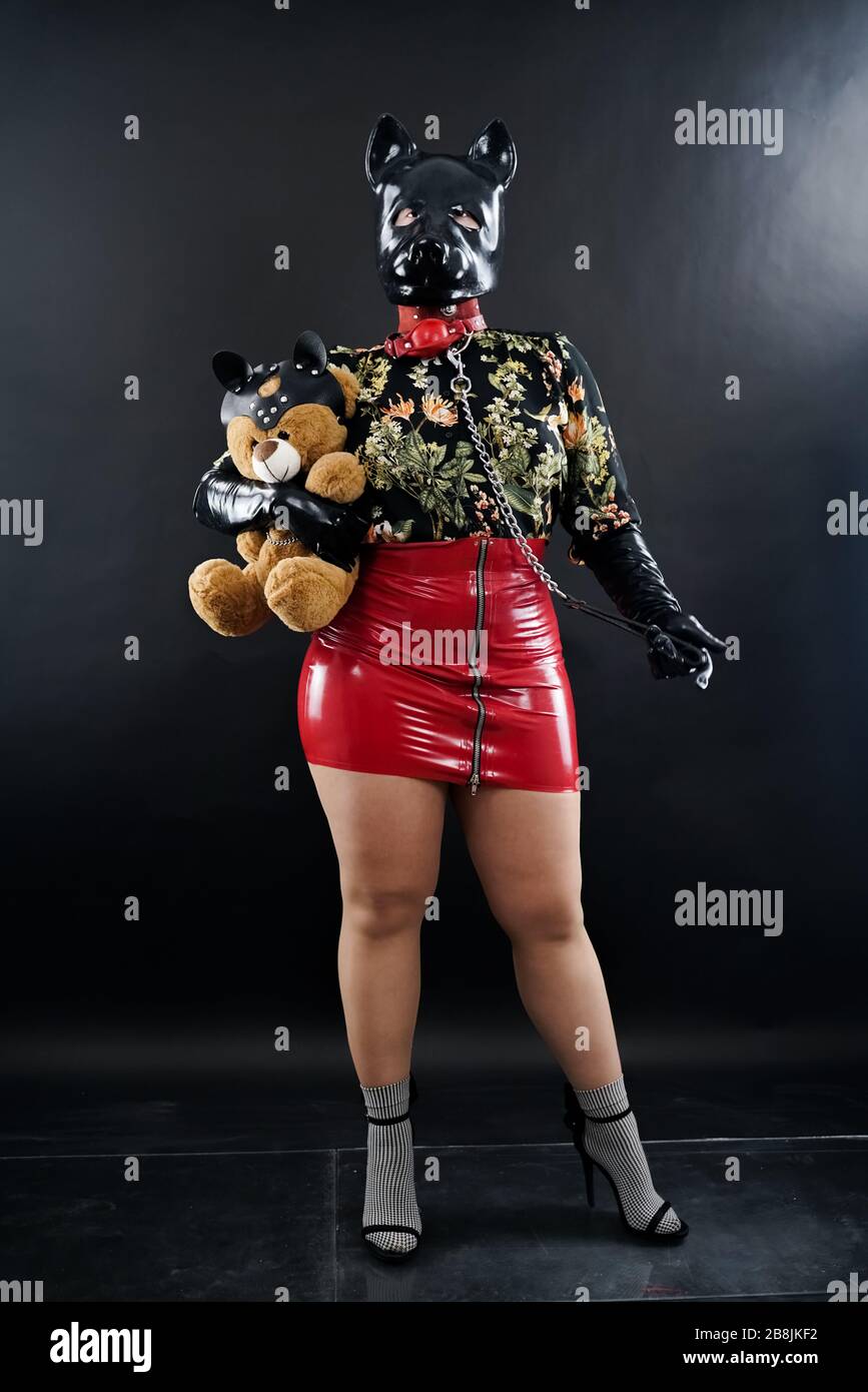 plus size woman with rubber mask for protection posing with her teddy ...