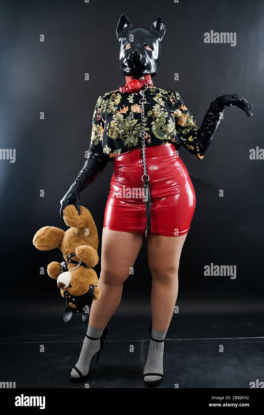 plus size woman with rubber mask for protection posing with her teddy ...
