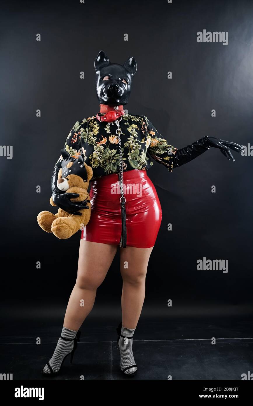 plus size woman with rubber mask for protection posing with her teddy ...