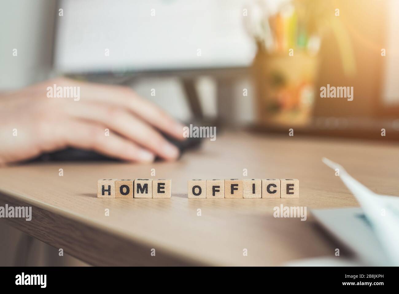 “Home Office” letters in foreground, man working in home office in ...