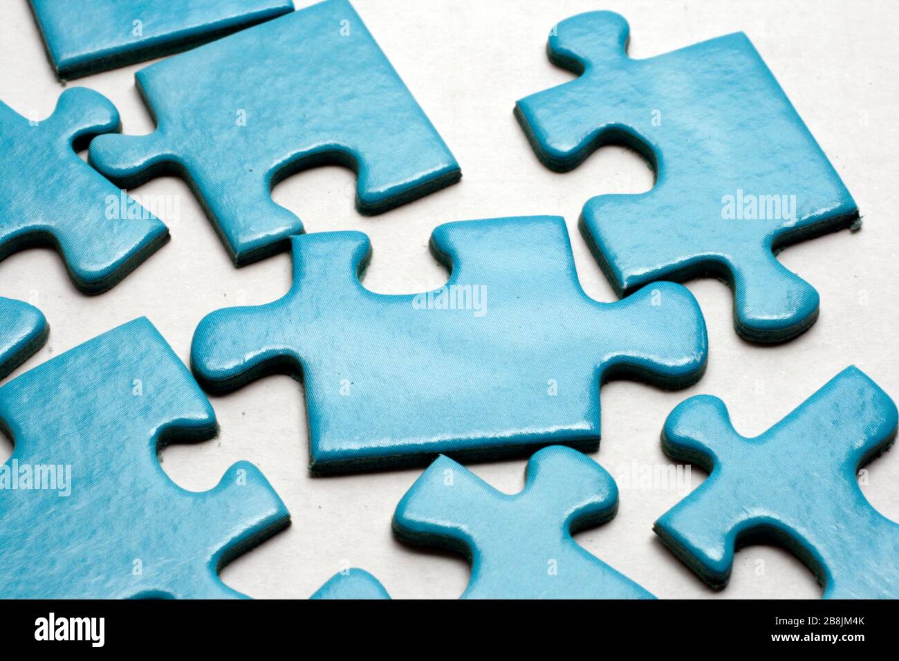 Blue puzzle pieces on white background Stock Photo - Alamy