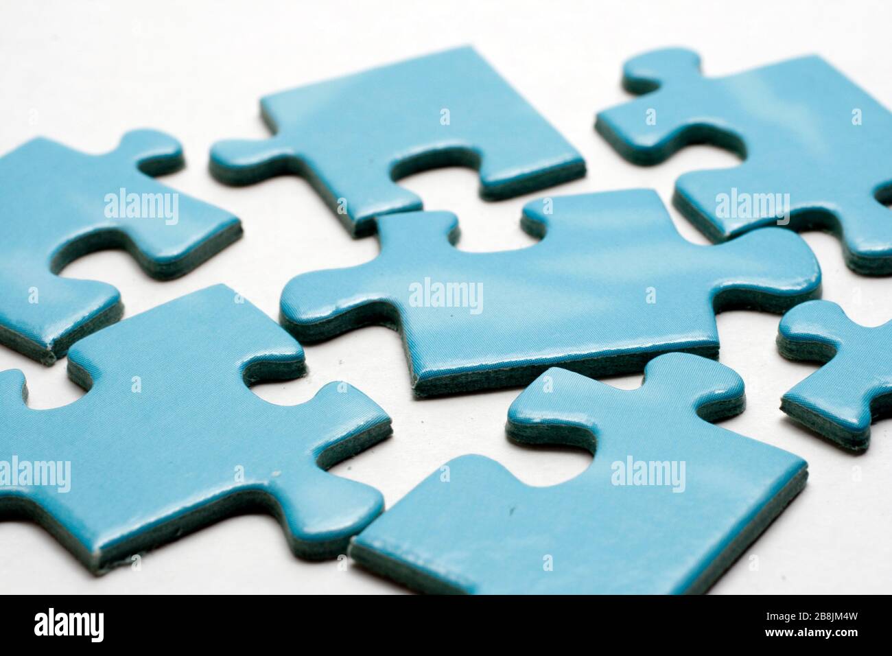 Blue puzzle pieces on white background Stock Photo - Alamy