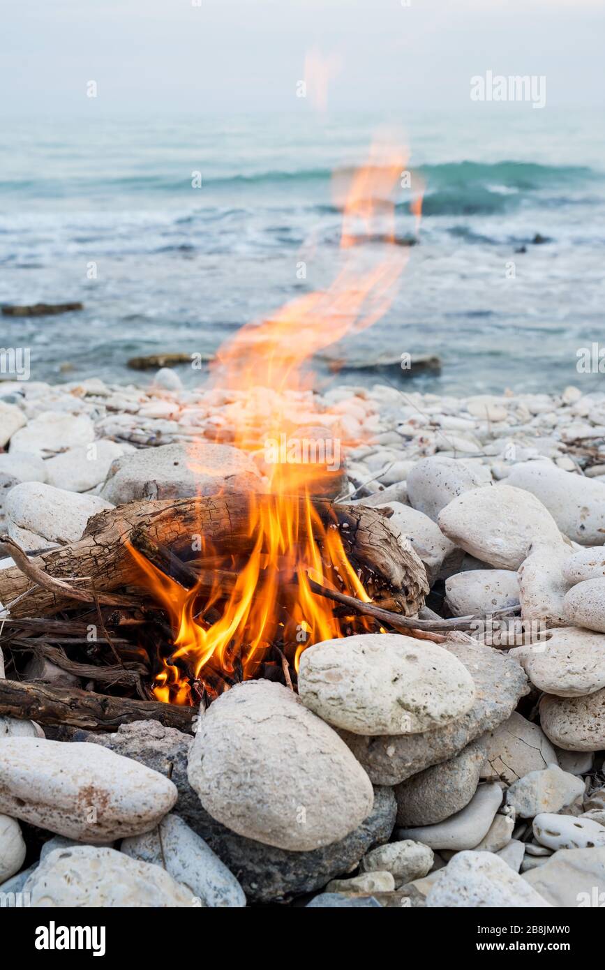 Campfire on the beach at sunset hi-res stock photography and images - Alamy