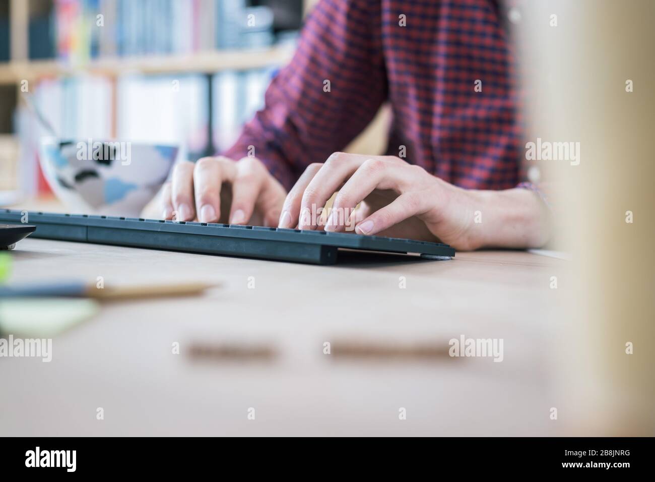 Typing hands on keyboard, home office with text space Stock Photo - Alamy
