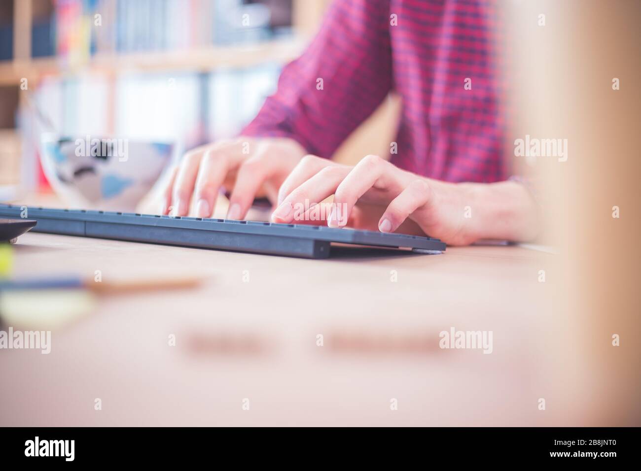 Typing hands on keyboard, home office with text space Stock Photo - Alamy