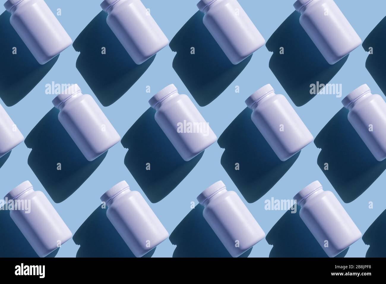 Repeating white cans of pills on a blue background, background in pop ...