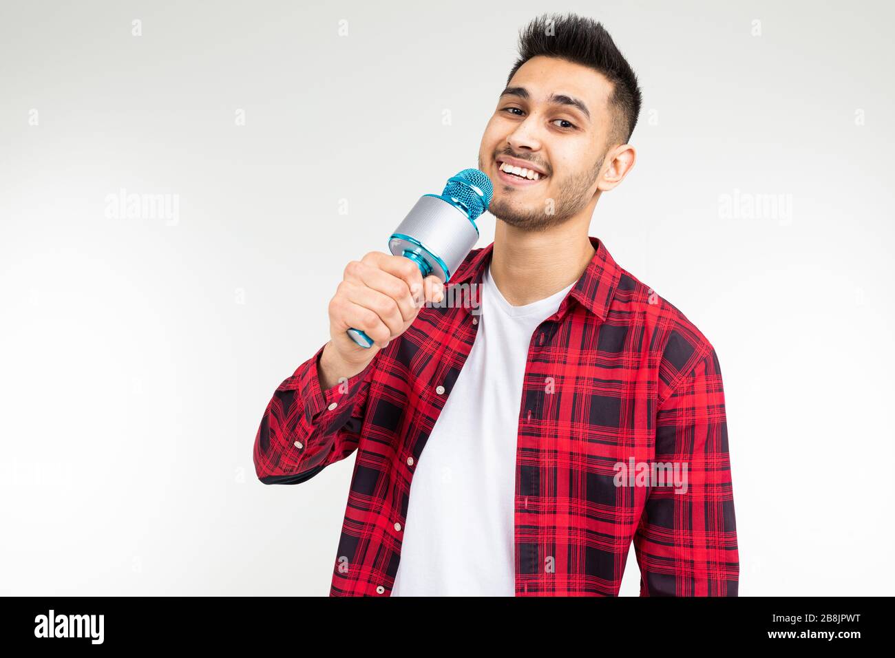 performer guy singer in a shirt with a microphone in his hands on a ...