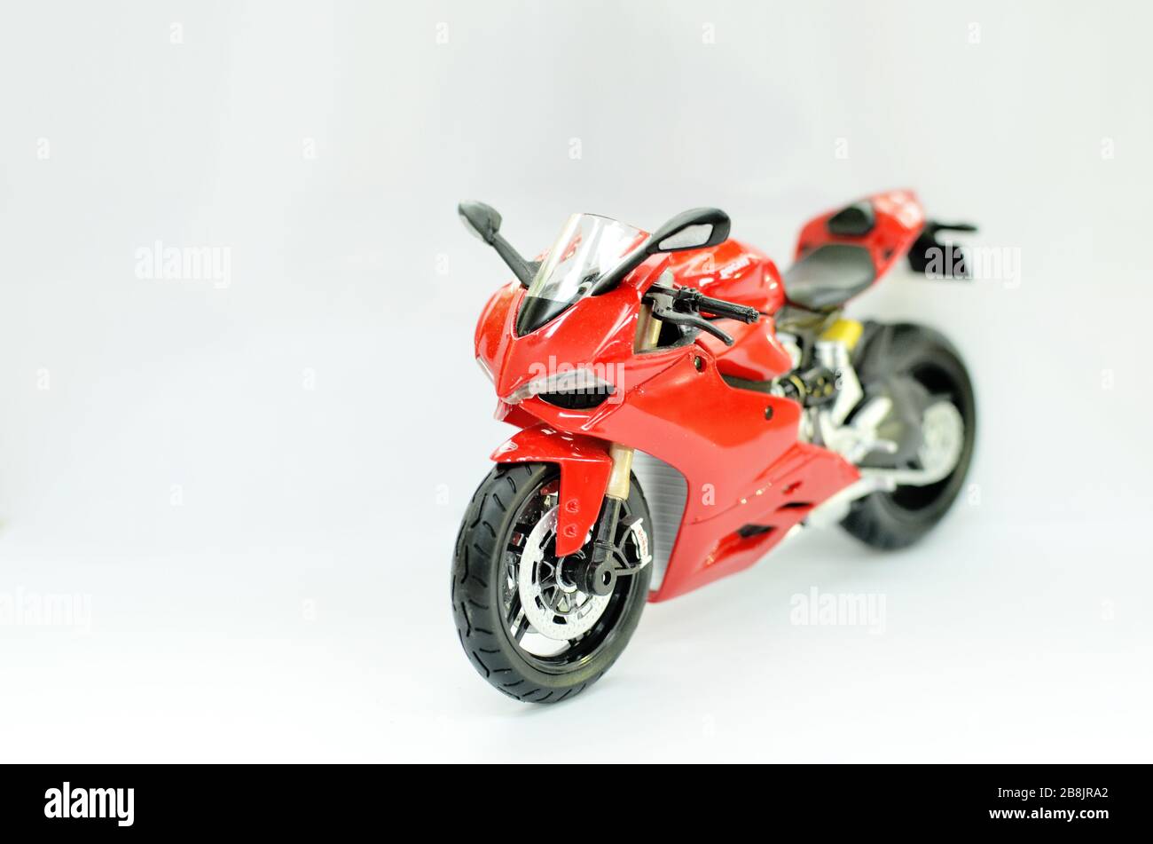 Red motorcycle toy in white background Stock Photo - Alamy