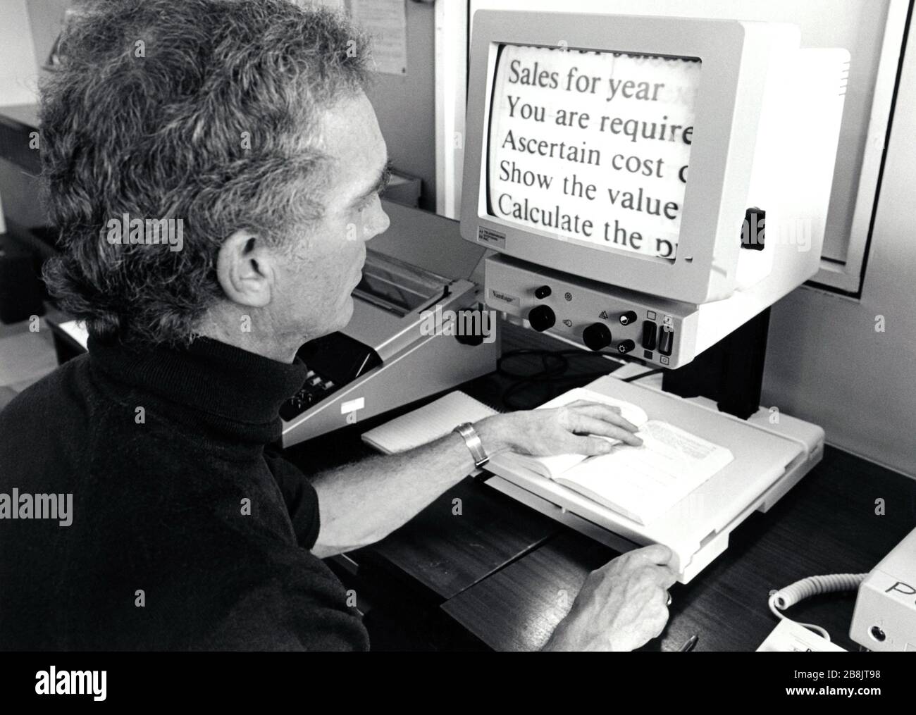 Visually impaired man using large print screen at RNIB Loughborough, UK ...