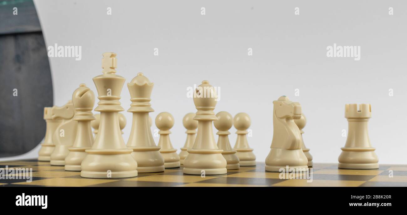 White figures in a row on a chessboard on isolated white background ...