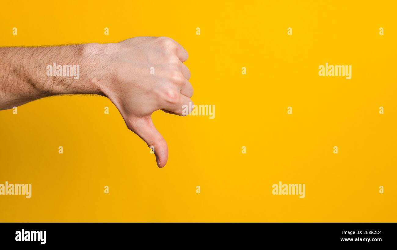 not good and not approved. close up hand of a man showing thumb down ...