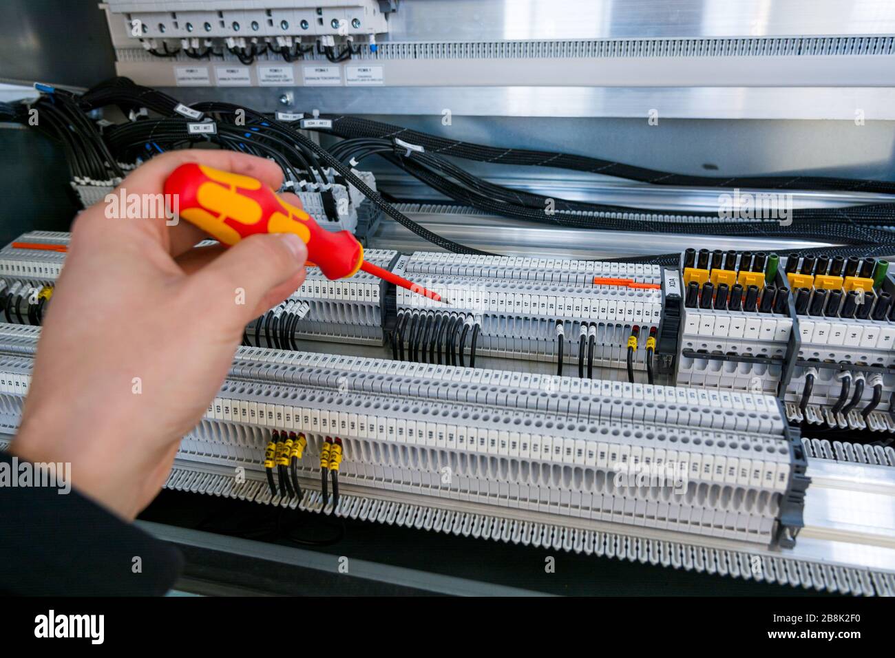 Installing a new connector in electric cubicle Stock Photo - Alamy