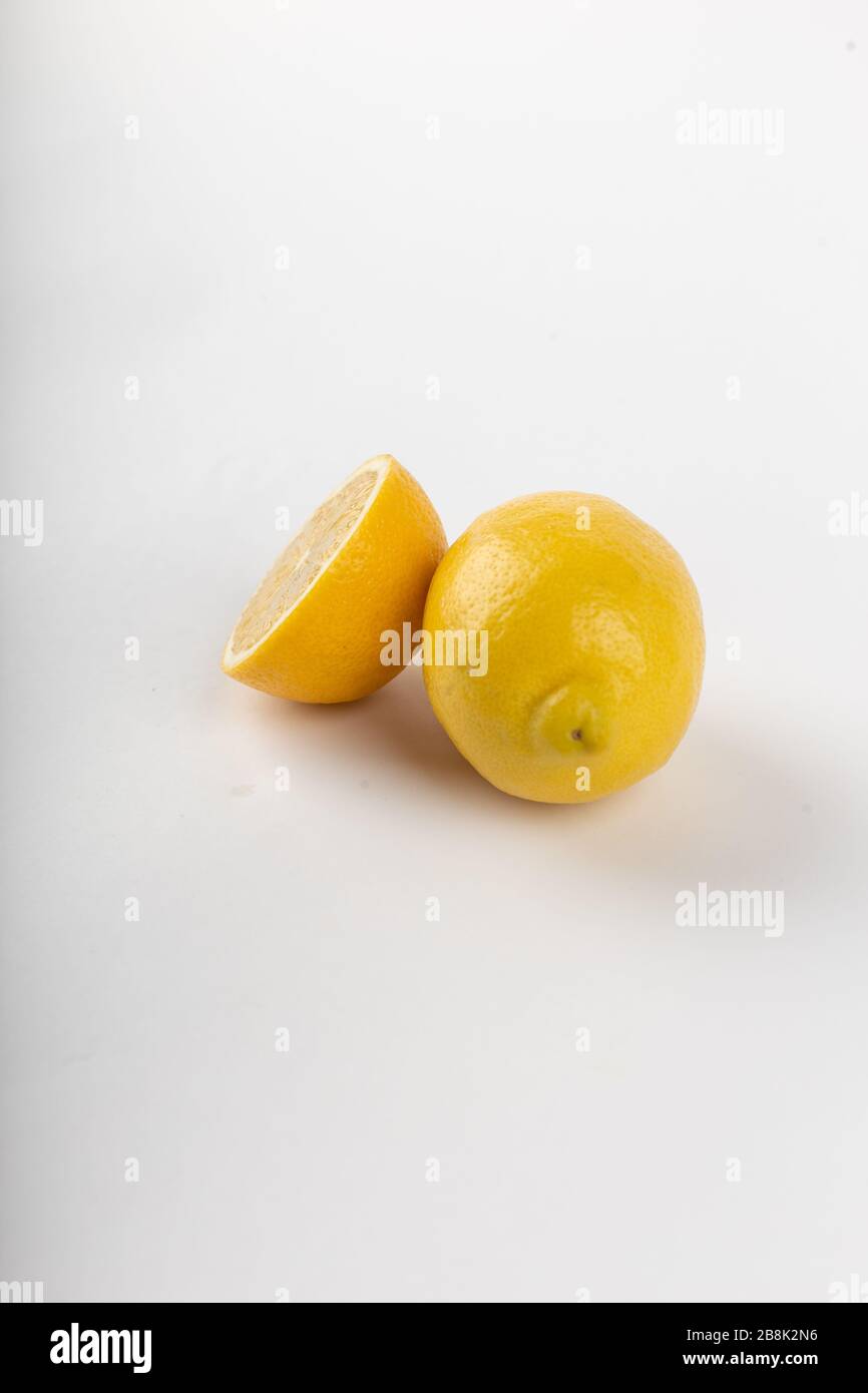 Whole and a half lemon isolated on white Stock Photo - Alamy