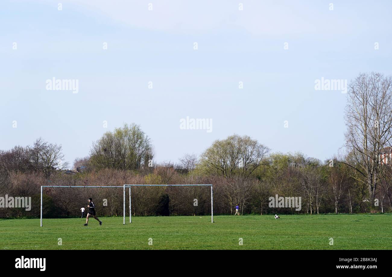 People exercise at Hackney Marshes in London, as all grassroots ...
