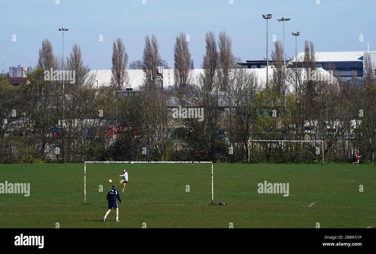 People play football at Hackney Marshes in London, as all grassroots ...