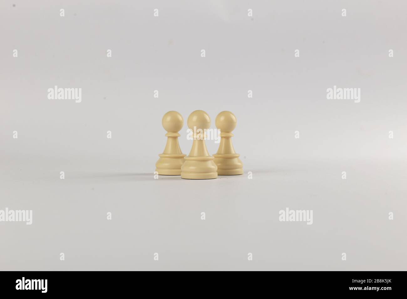 White multiple pawn figures isolated on white background Stock Photo ...